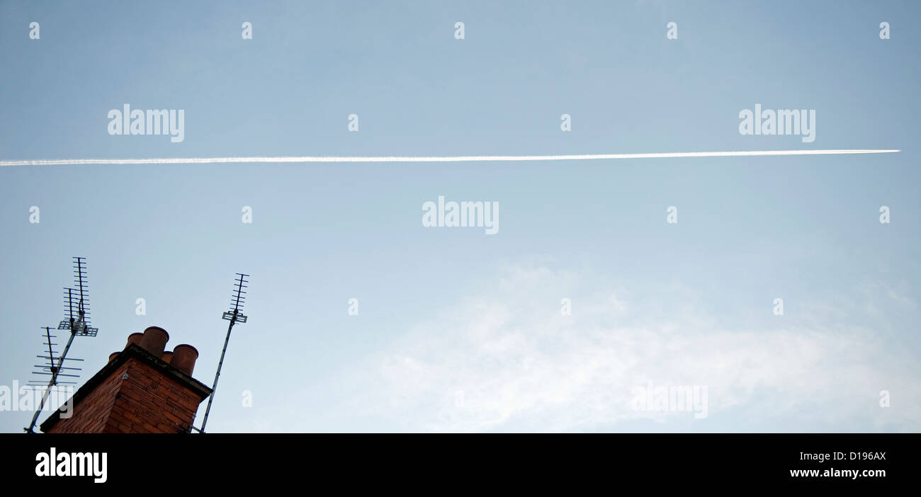 The vapour trail of a jet aircraft burning fuel in the blue sky Stock ...