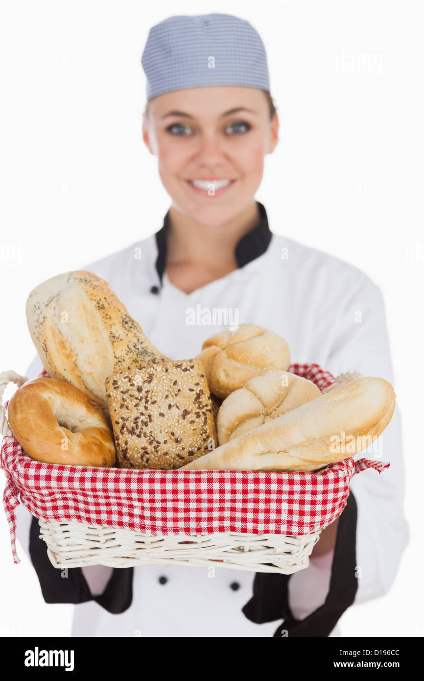 Female chef with fresh breads in basket Stock Photo - Alamy