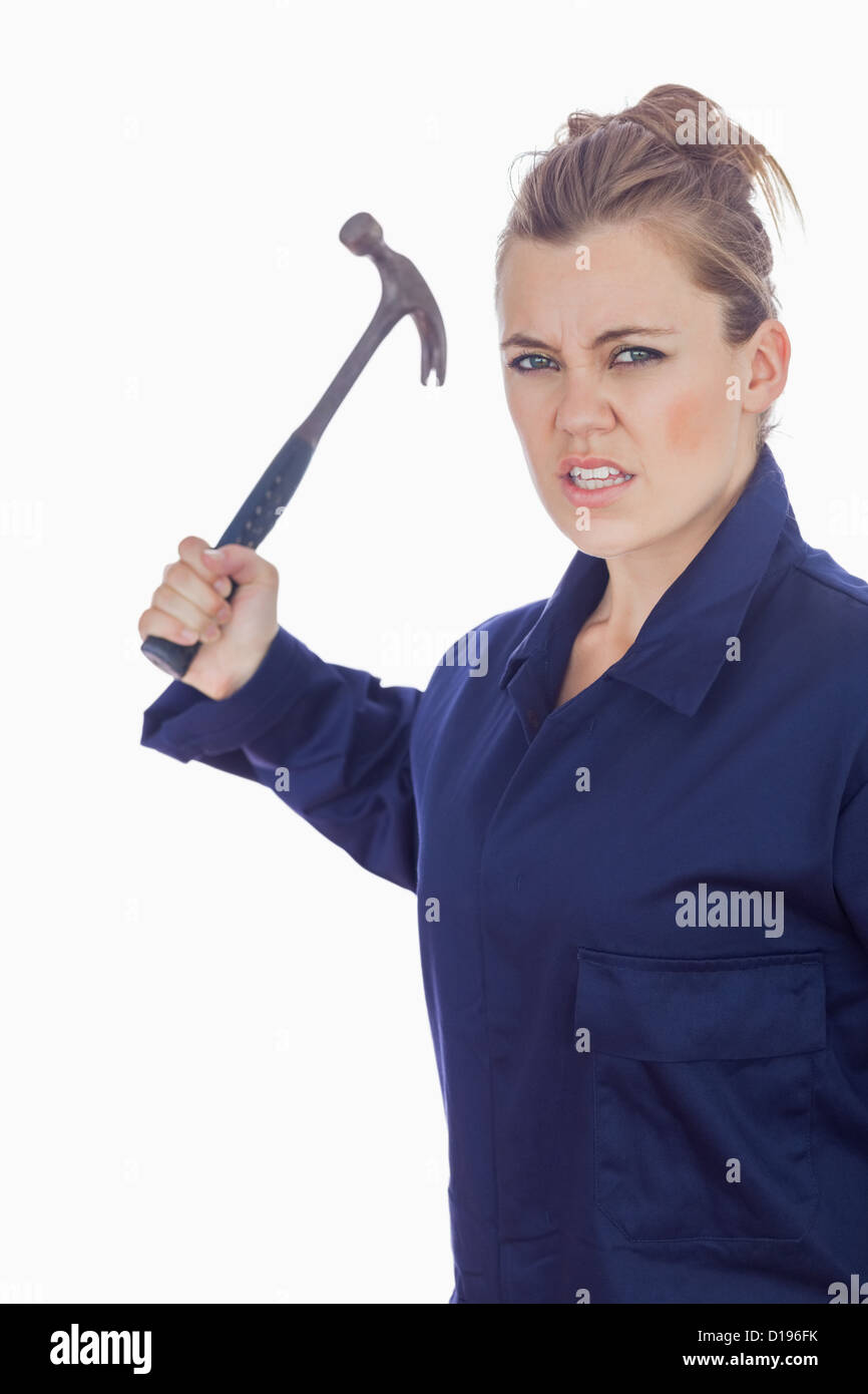 An angry female mechanic holding claw hammer Stock Photo - Alamy