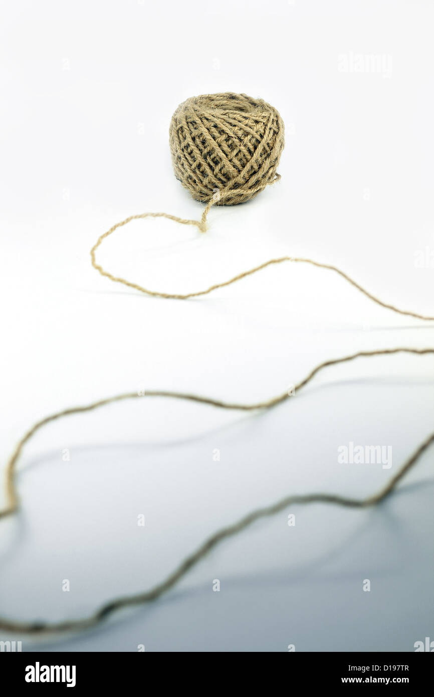 Hank of twine with string coming out of it Stock Photo - Alamy