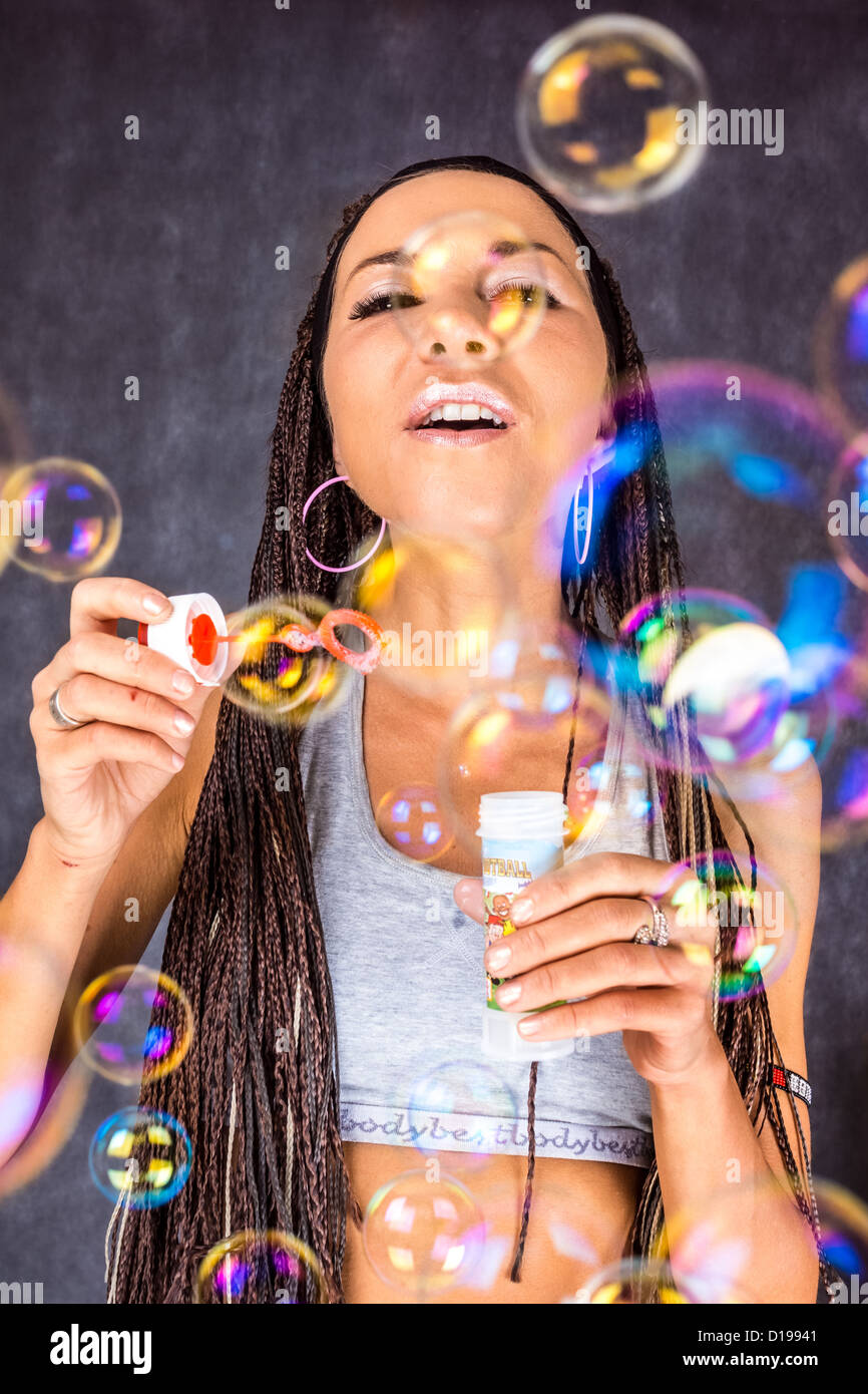 Beautiful female blowing bubbles hi-res stock photography and images ...