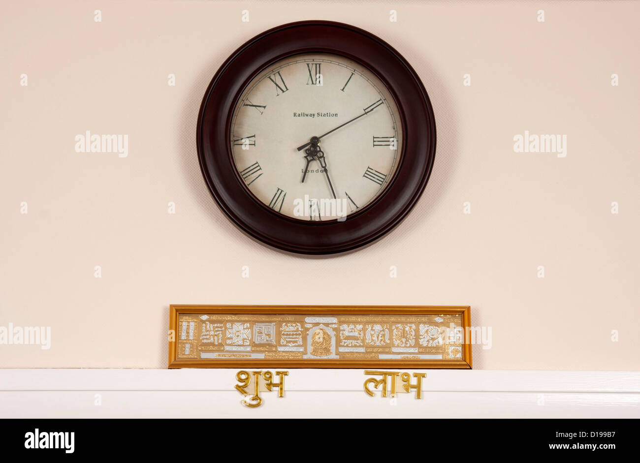 Wall clock and auspicious scripture of Jain religion Stock Photo - Alamy