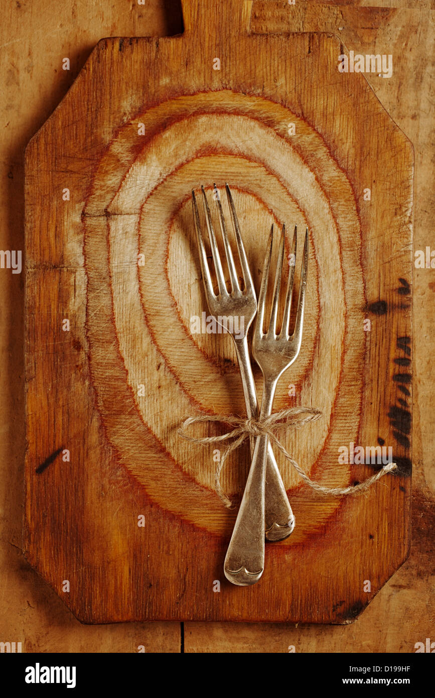 two fork tied by string on old wood, background Stock Photo - Alamy