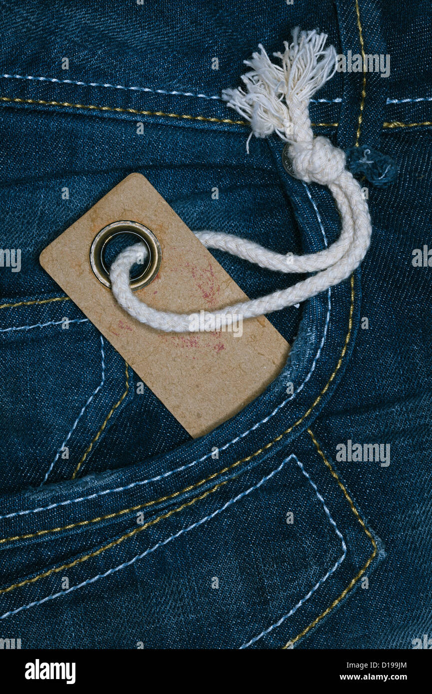 retro cardboard paper tag with string in denim jeans pocket Stock Photo ...
