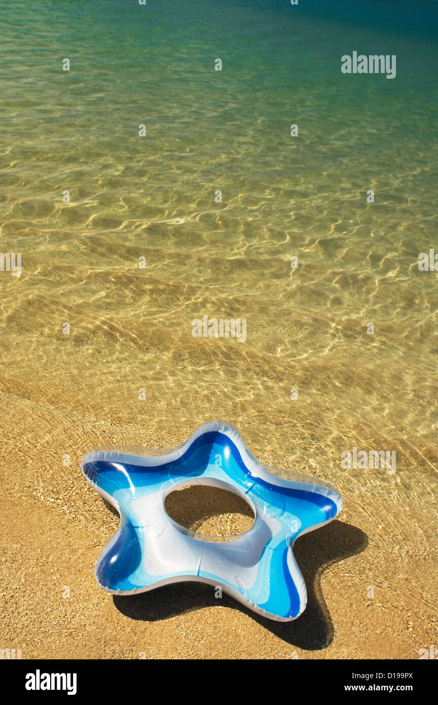 Blue And White Star Swim Ring Resting At On The Beach Stock Photo - Alamy