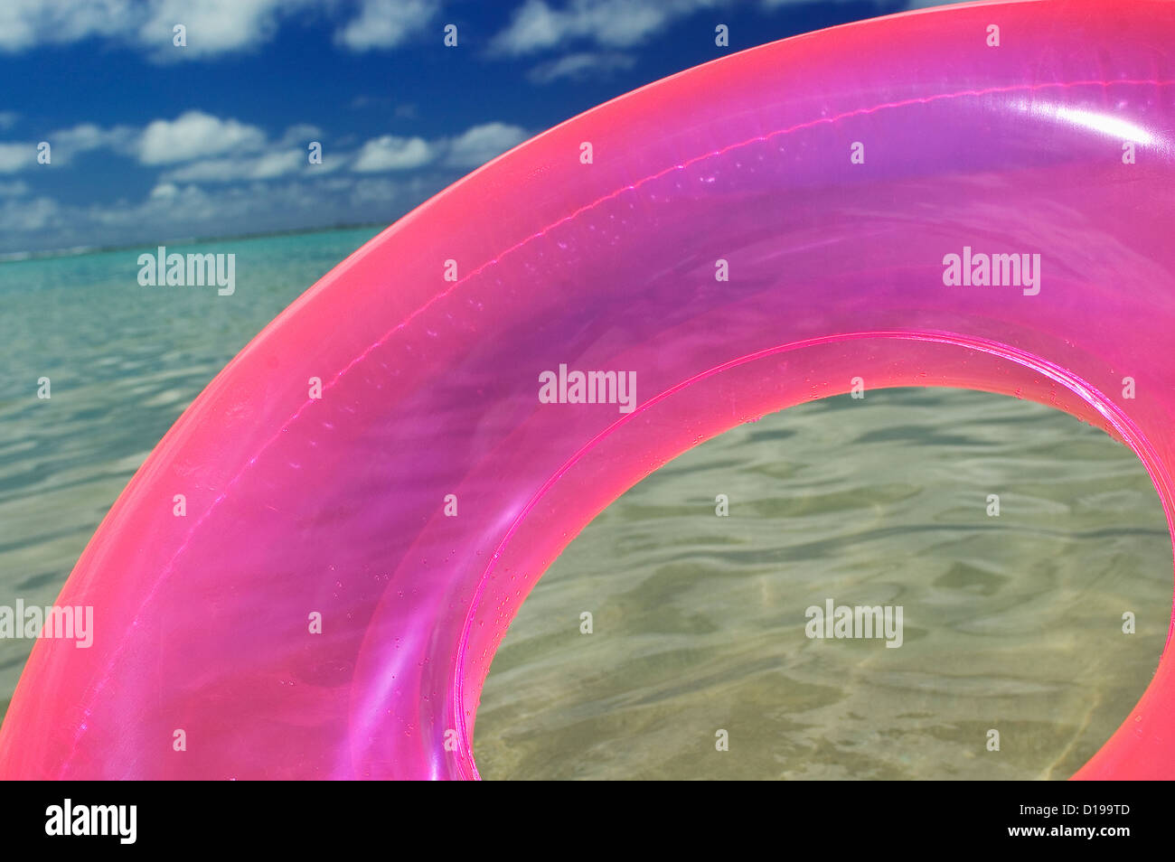 Pink Swim Ring Held Above Ocean Stock Photo Alamy