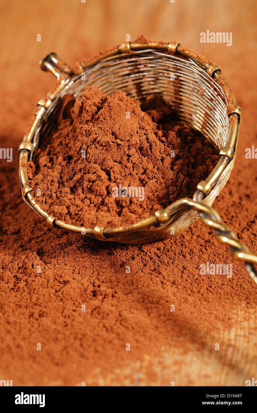 cocoa powder in old rustic style silver sieve, shallow dof Stock Photo ...