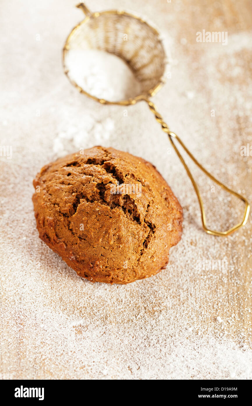 soft ginger cookie on wooden table, sieve with caster sugar on ...