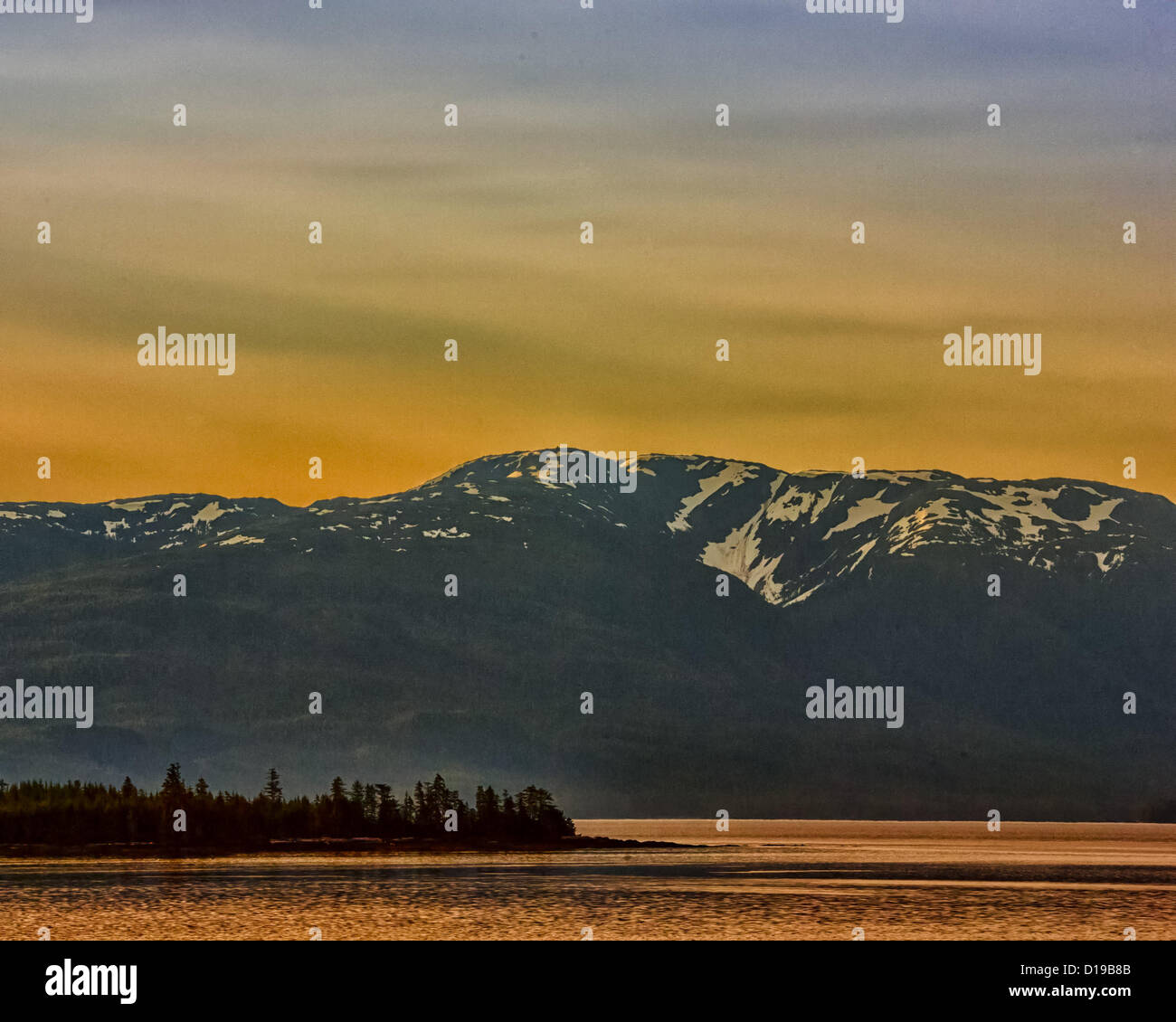 July 6, 2012 - Inside Passage, Alaska, US - The glow of early morning ...