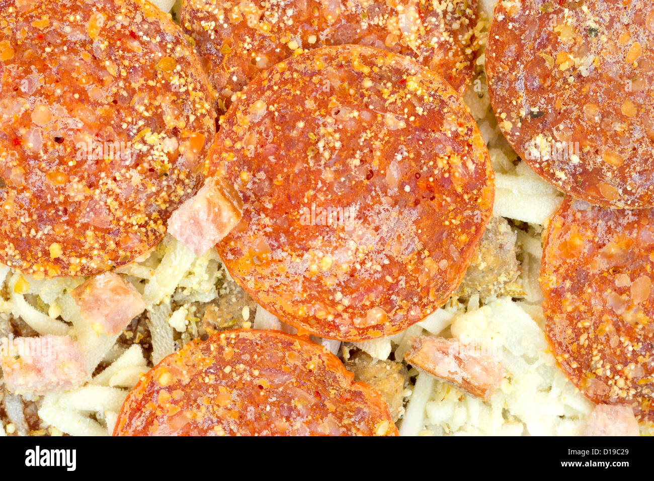 A very close view of pepperoni, ham and sausage frozen pizza Stock ...