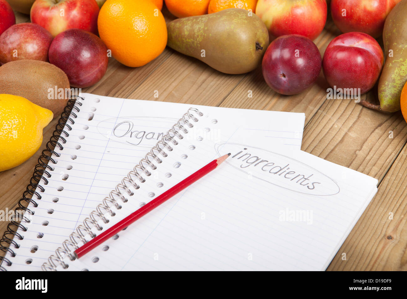 Pencil and books with fruits Stock Photo - Alamy