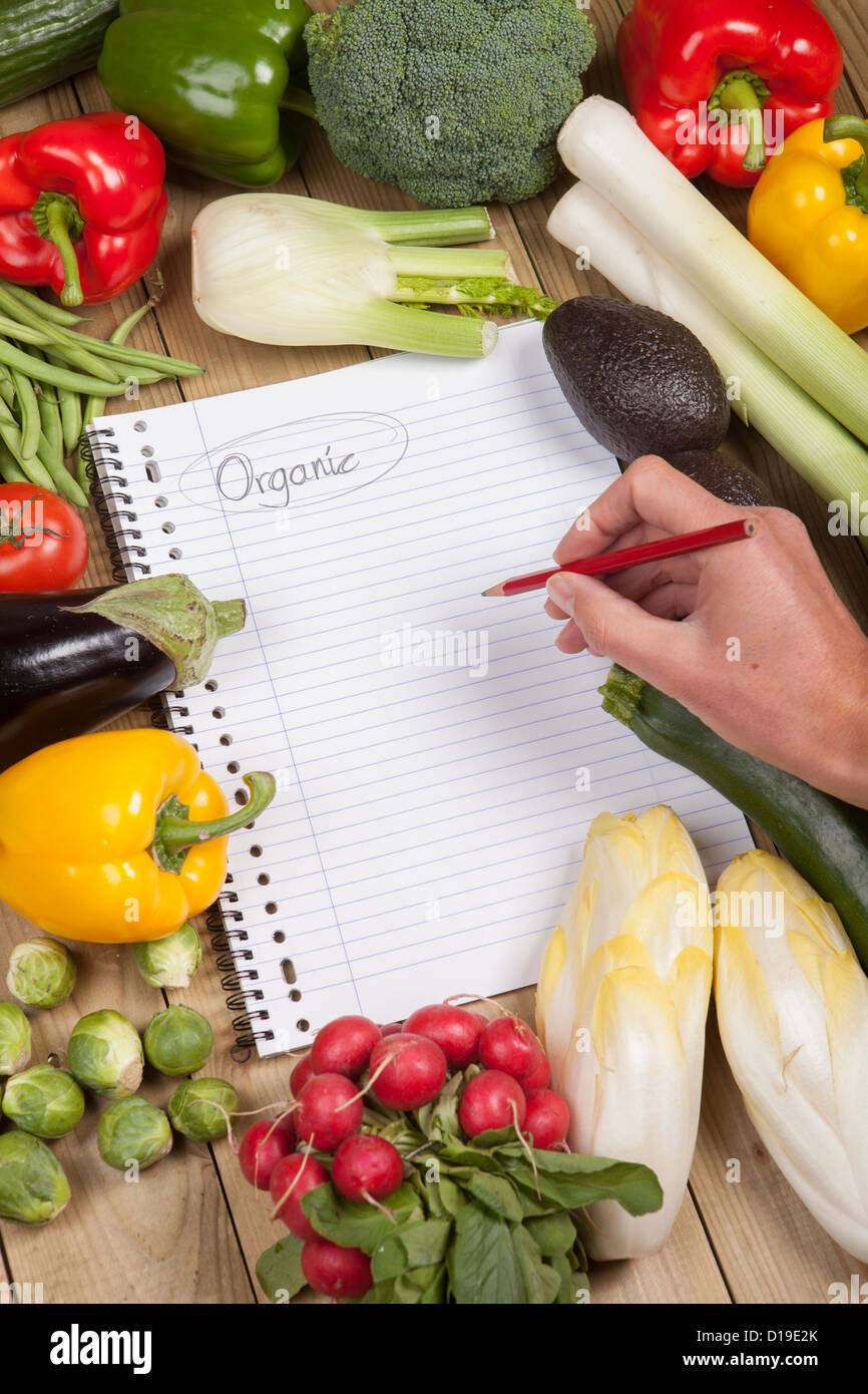 Hand writing list of organic vegetables Stock Photo - Alamy