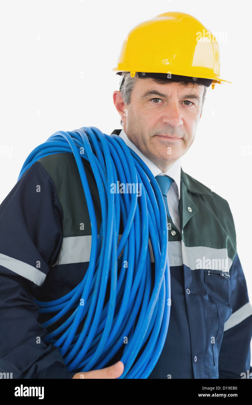 Mature man wearing hardhat with cable Stock Photo - Alamy