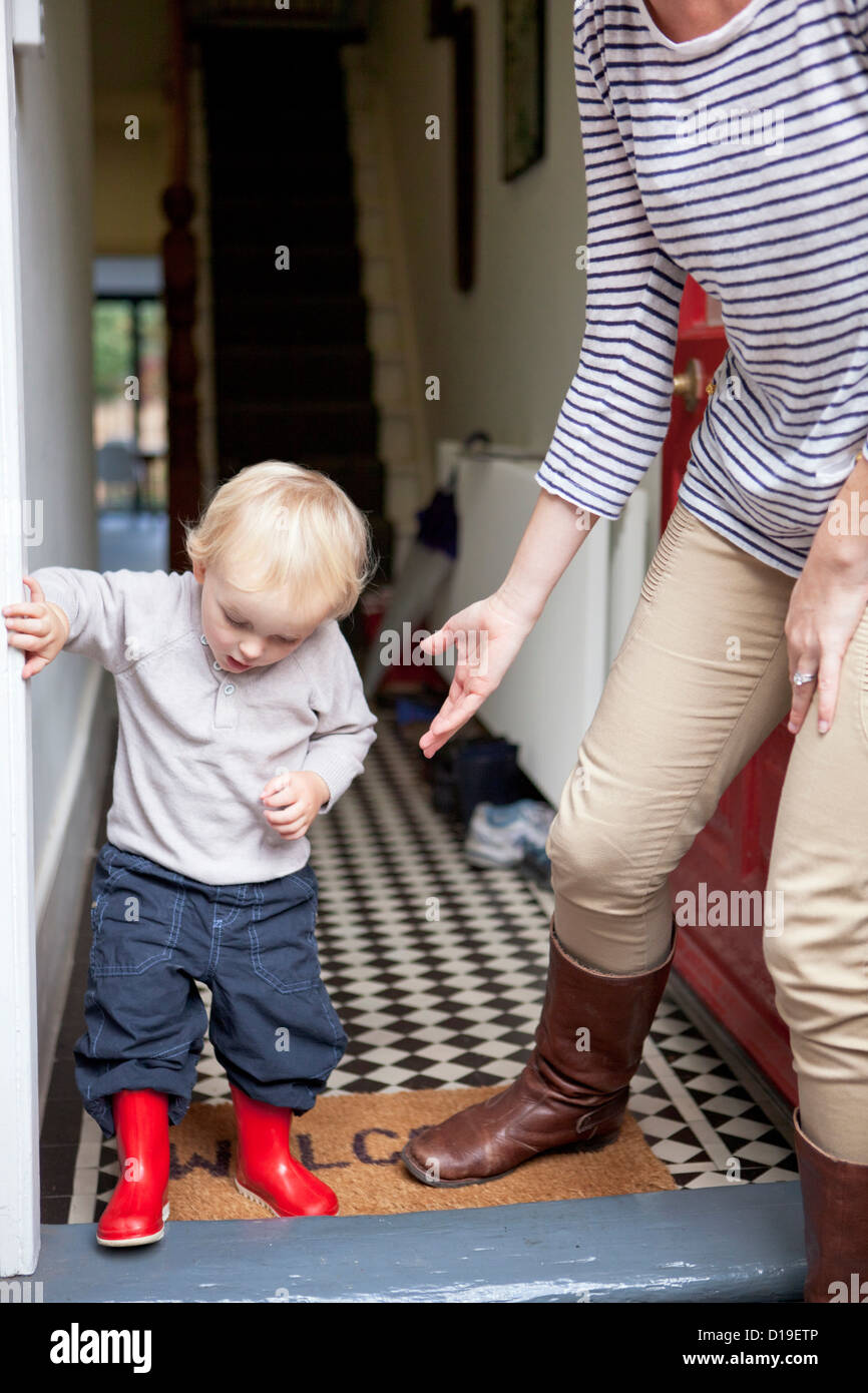 Boy stepping out door hi-res stock photography and images - Alamy