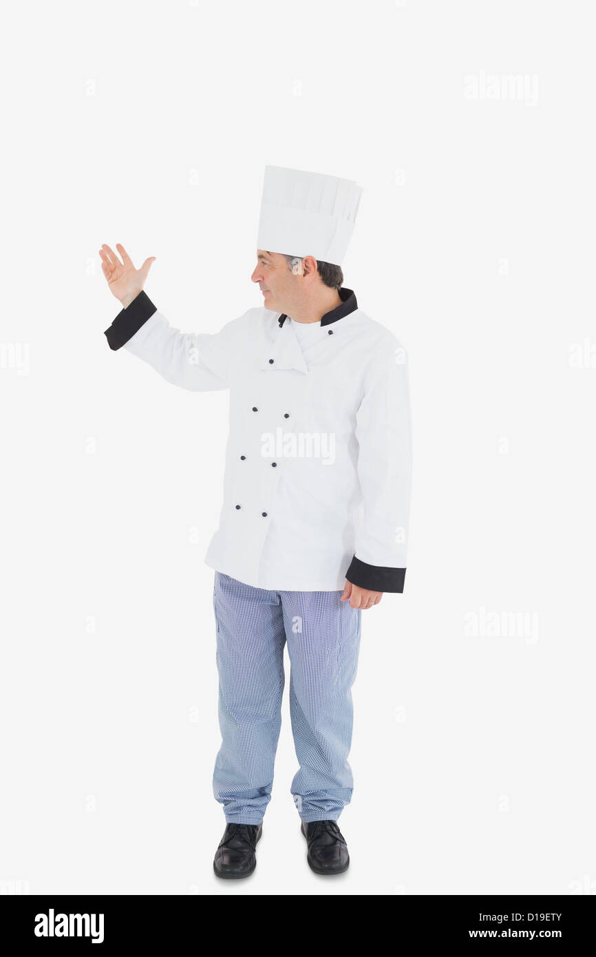 Confident chef showing something on white Stock Photo - Alamy
