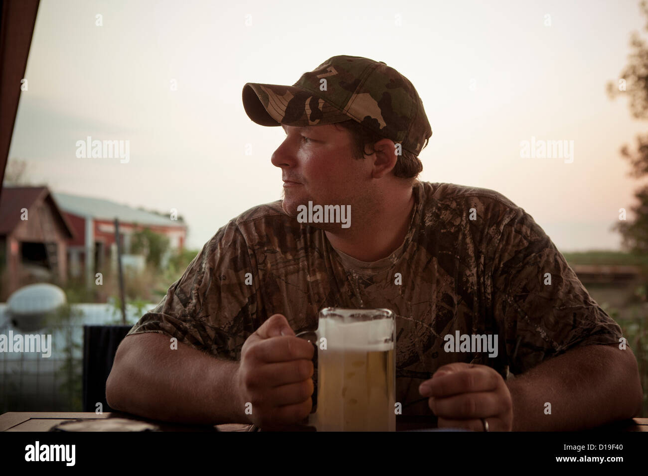 Man wearing baseball cap with beer Stock Photo - Alamy