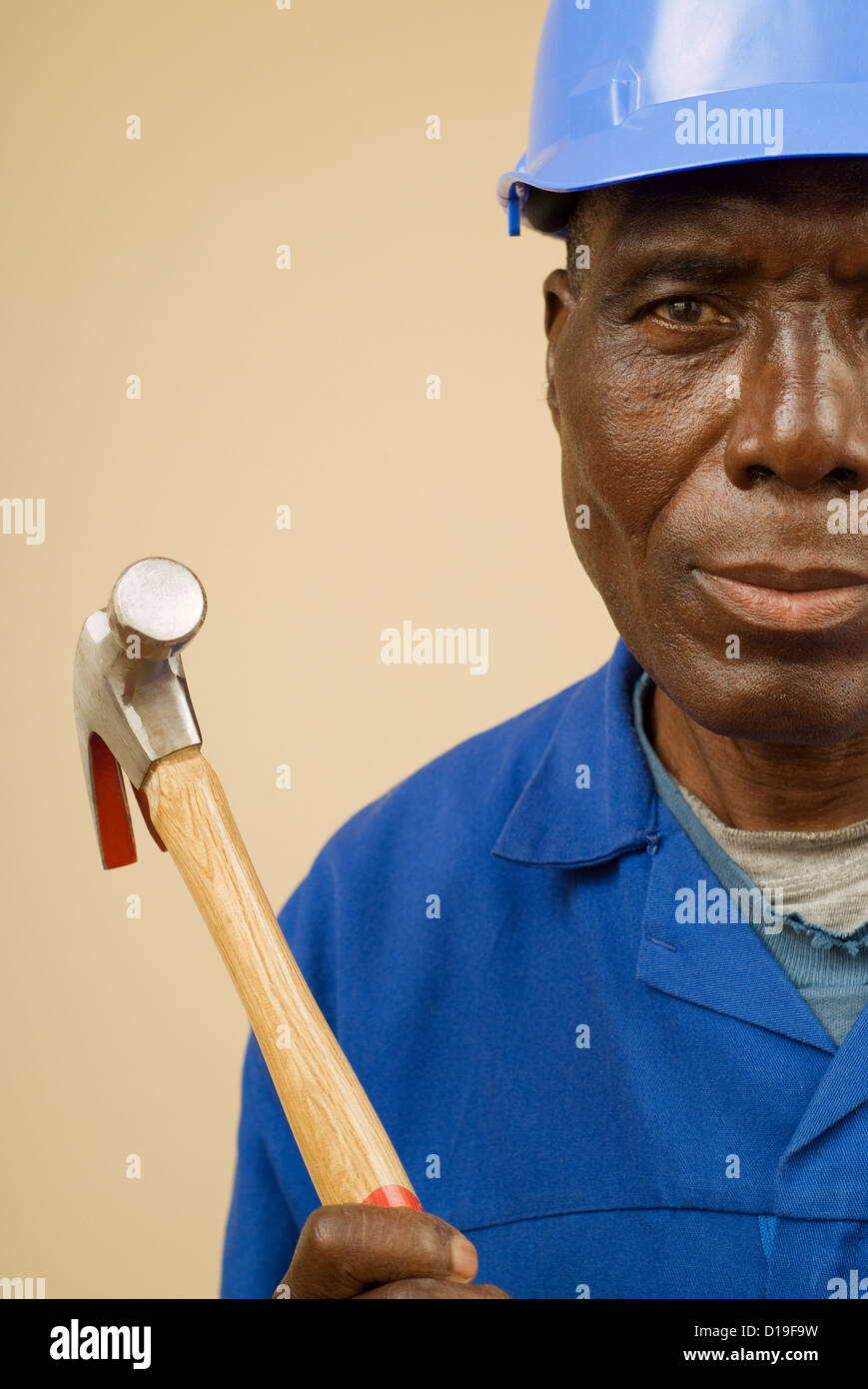 Construction worker holding hammer, builder, handyman Stock Photo - Alamy