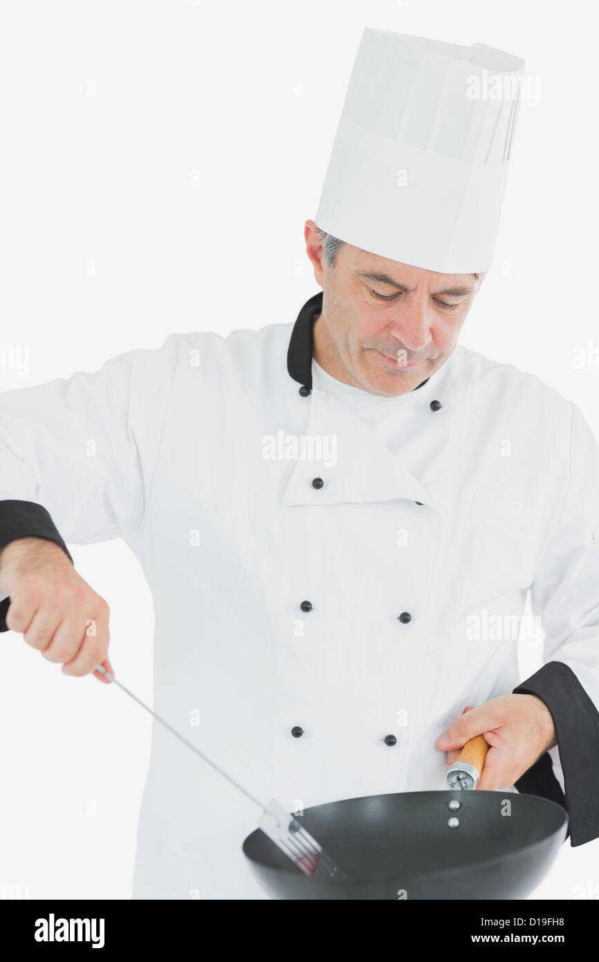 Chef using spatula and frying pan Stock Photo - Alamy