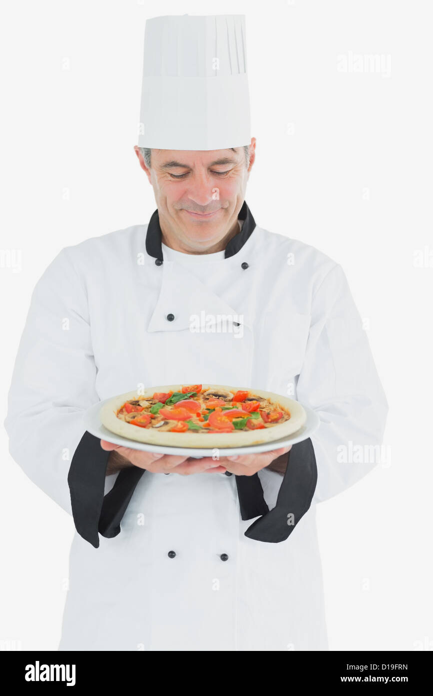 Happy chef holding pizza Stock Photo - Alamy