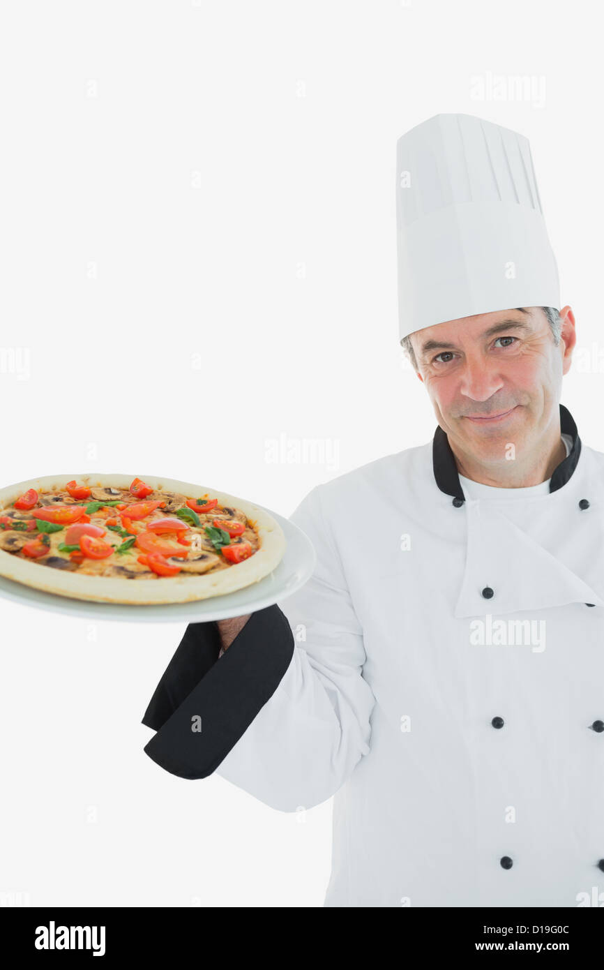 Happy chef holding pizza Stock Photo - Alamy