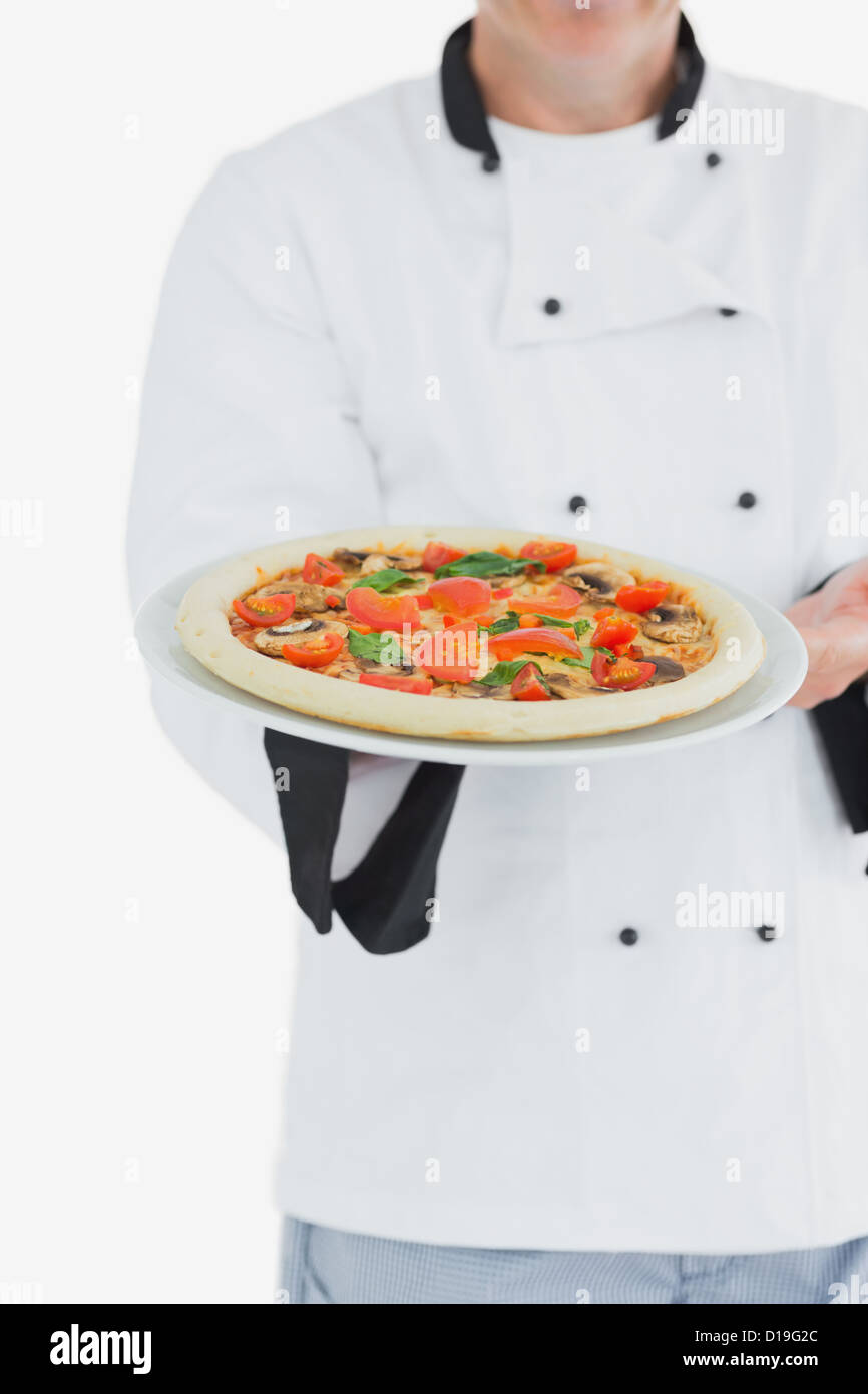 Male chef offering pizza Stock Photo - Alamy