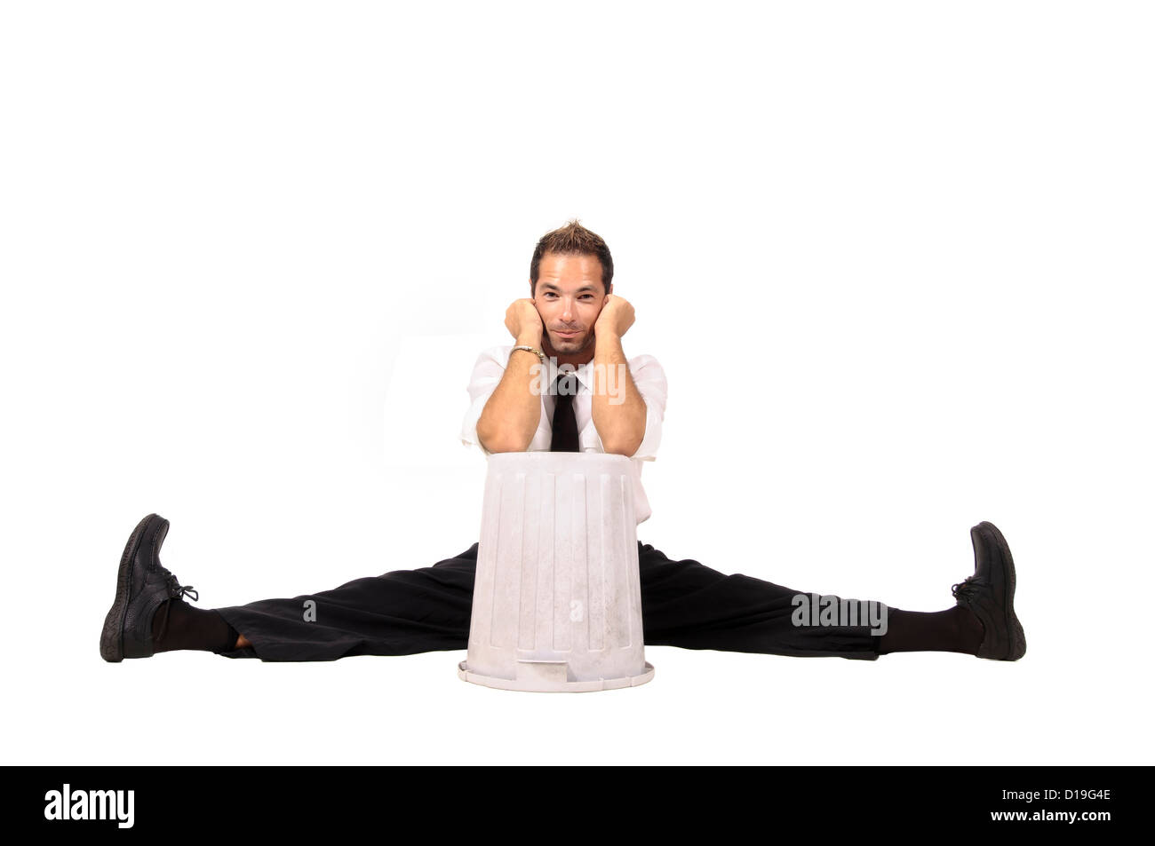 Businessman doing splits with office trash Stock Photo - Alamy