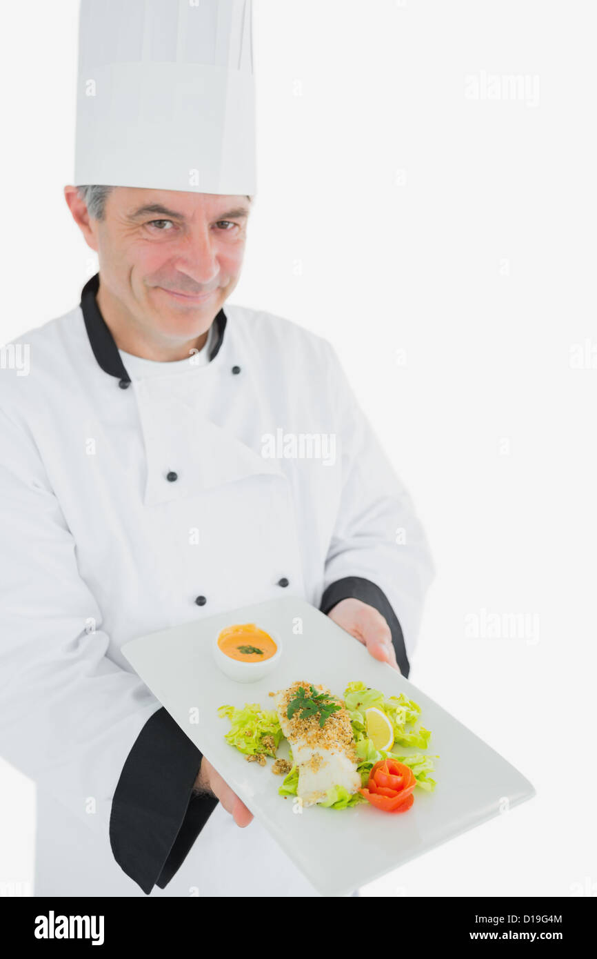 Chef offering fresh prepared meal Stock Photo - Alamy