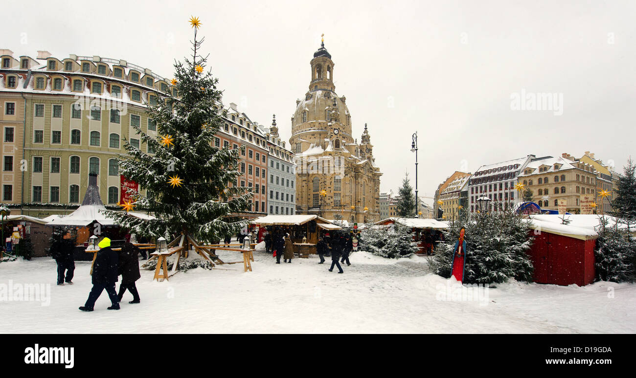 Visitors to the Christmas market at the Church of Our Lady walk through ...