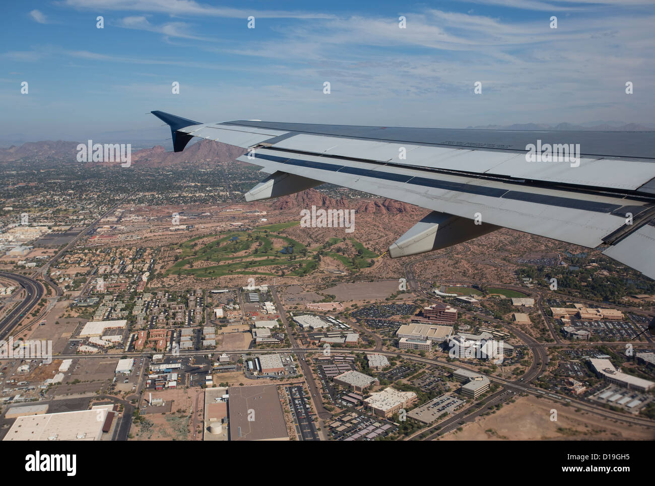 Aerial Phoenix Arizona city, looking under aircraft wing Stock Photo ...