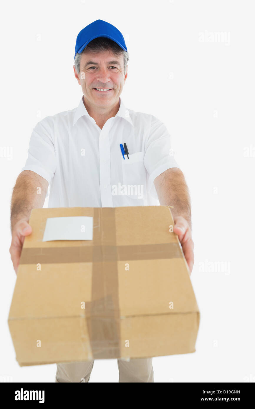 Happy delivery man giving package Stock Photo - Alamy