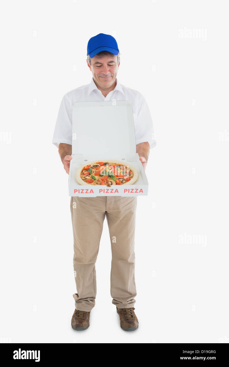 Mature delivery man looking at fresh pizza Stock Photo - Alamy
