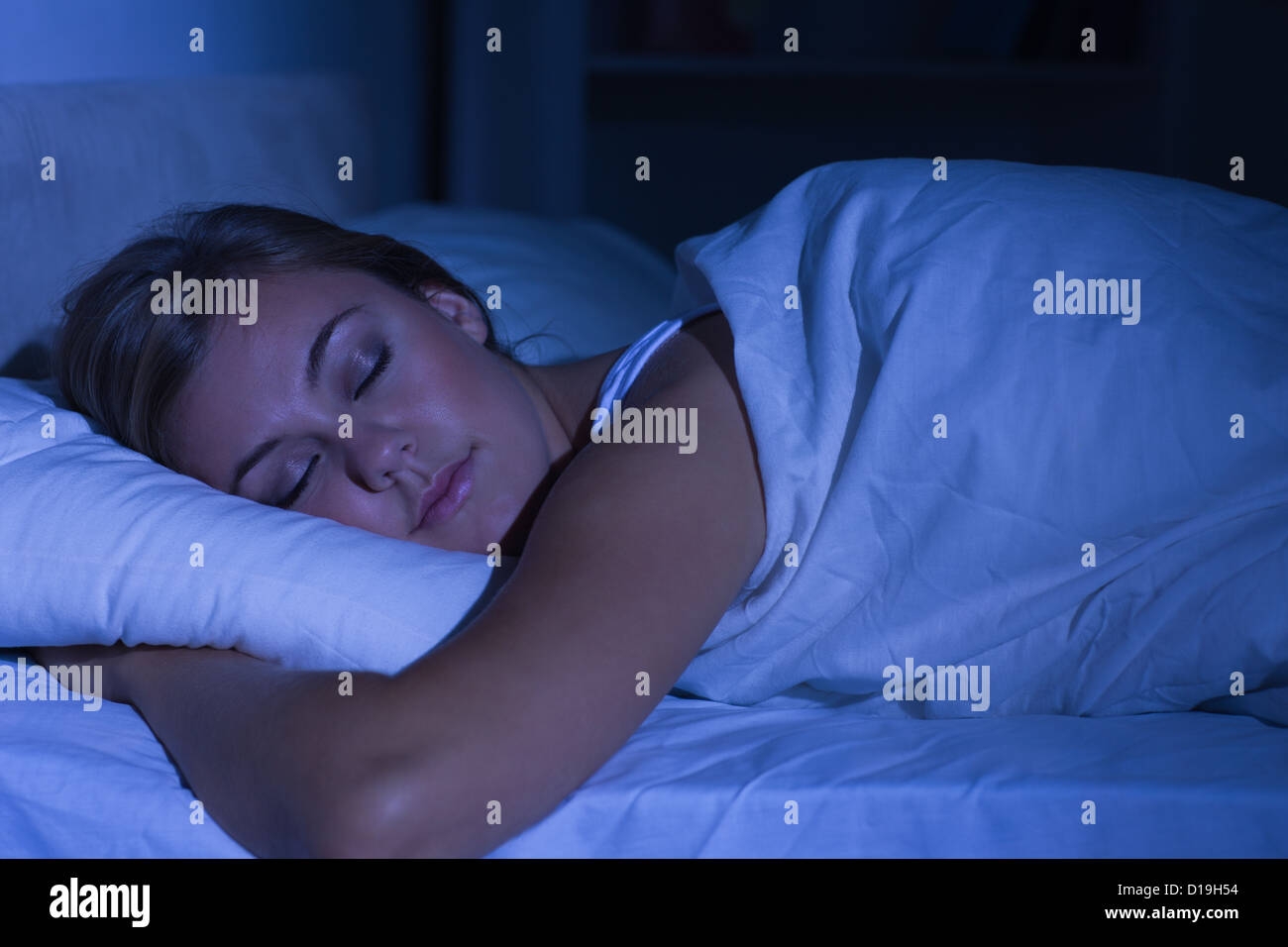 Serene woman sleeping at night Stock Photo - Alamy