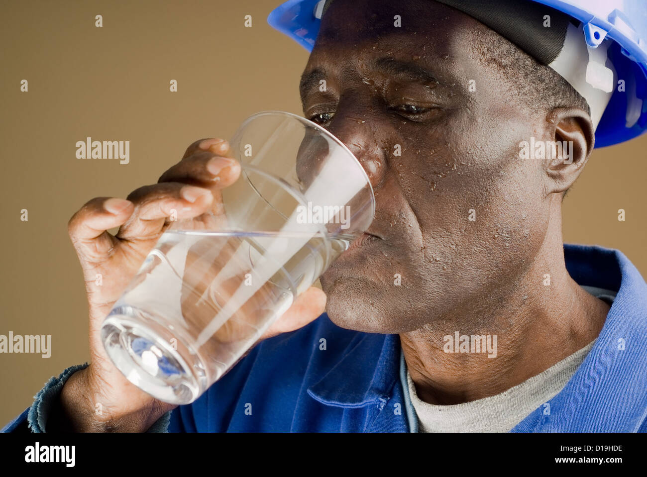 Tired Construction Worker Drinking Water Stock Photo - Alamy