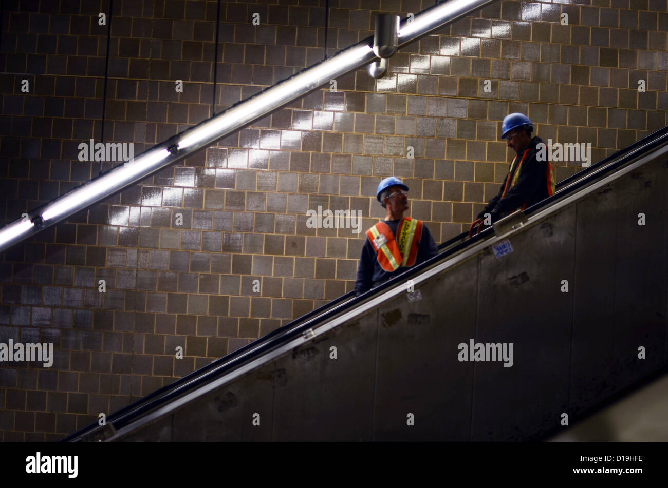Construction workers in subway mechanic stairs Stock Photo - Alamy