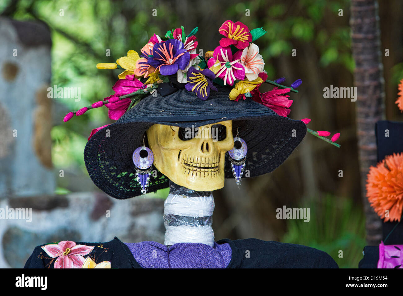 A skeleton dressed in clothes and a fancy hat to celebrate the Day of ...