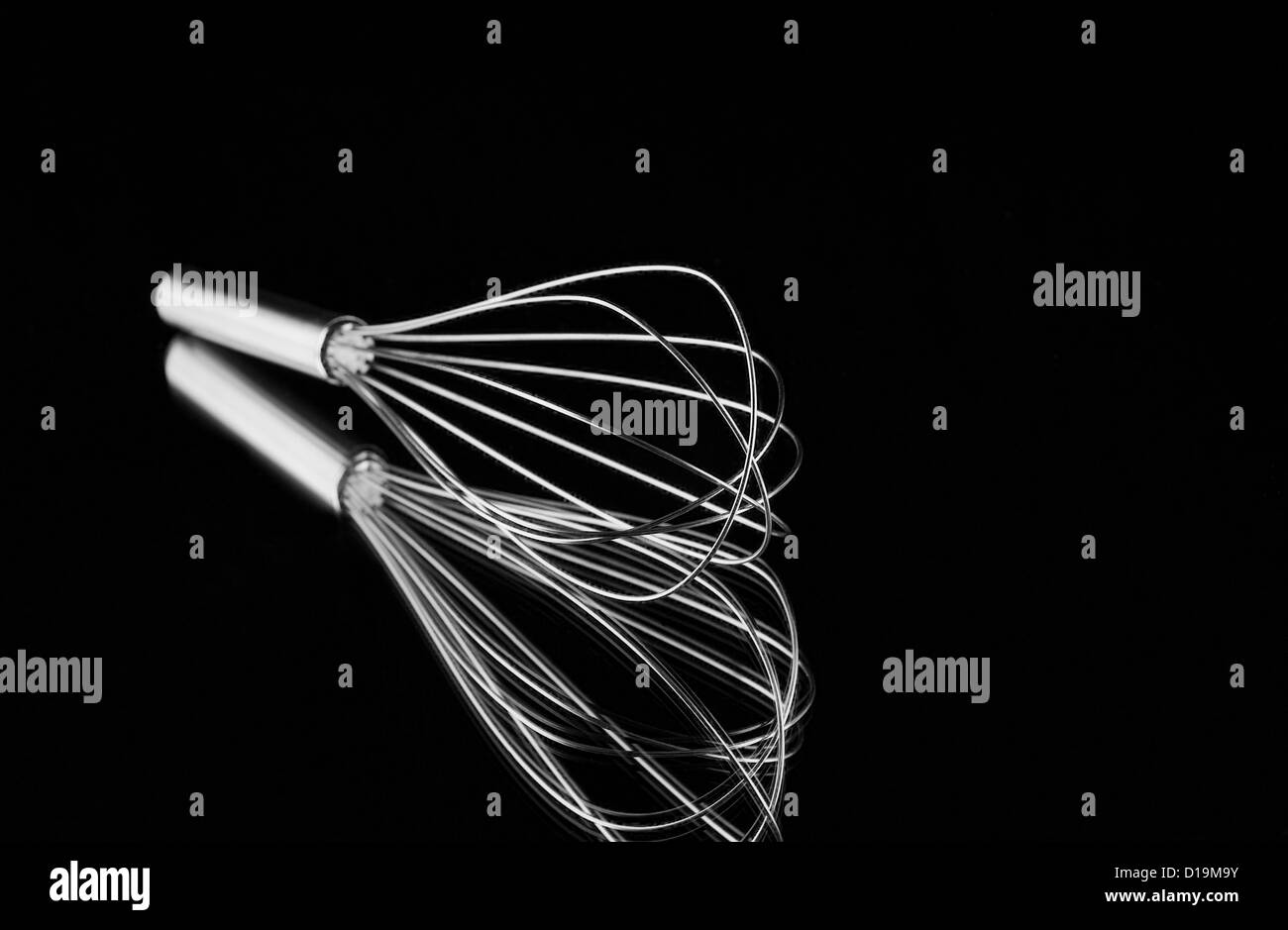 Metal whisk on black background reflecting in a mirror Stock Photo - Alamy