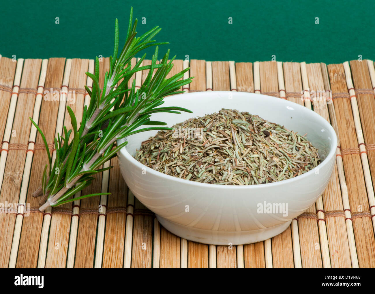 Sprig fresh rosemary and a bowl with dried rosemary Stock Photo - Alamy