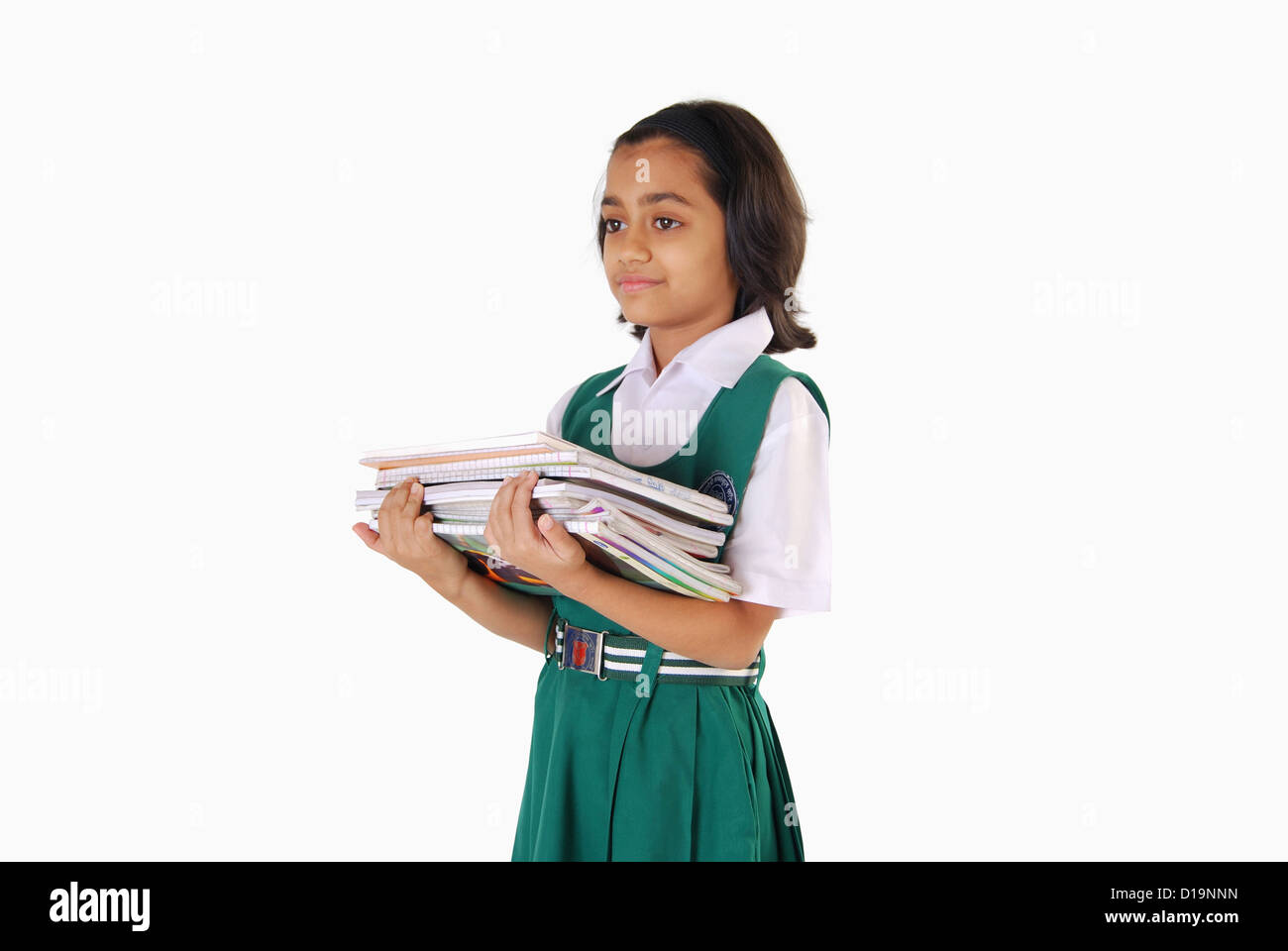 Schoolgirl (age 11 years) carrying notebooks in school uniform Stock ...