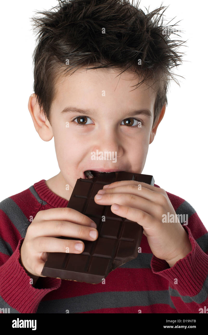 Smiling little boy eating chocolate. White isolated Stock Photo - Alamy
