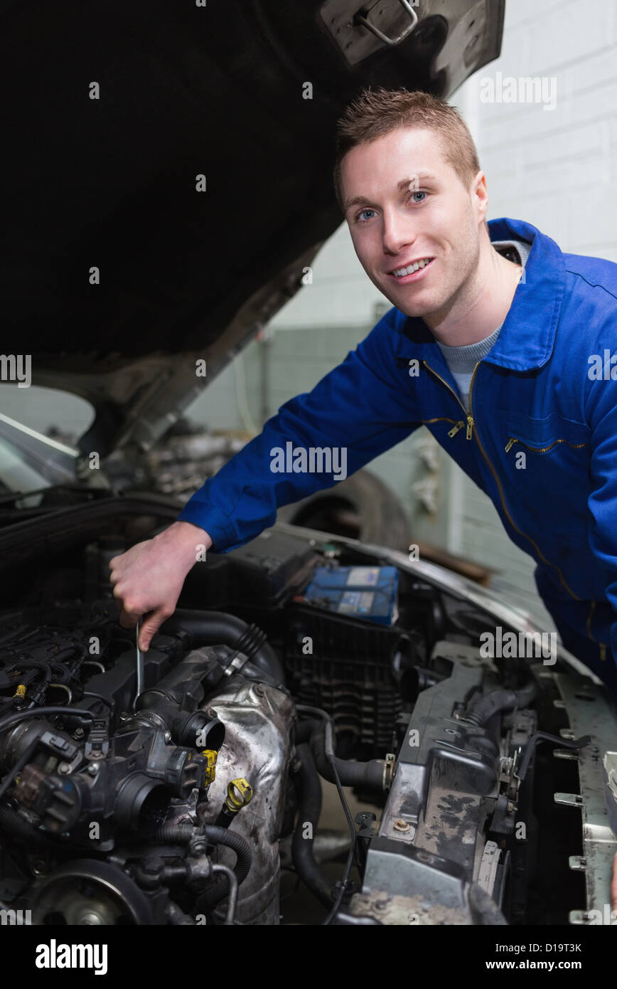 Young mechanic repairing car engine Stock Photo - Alamy