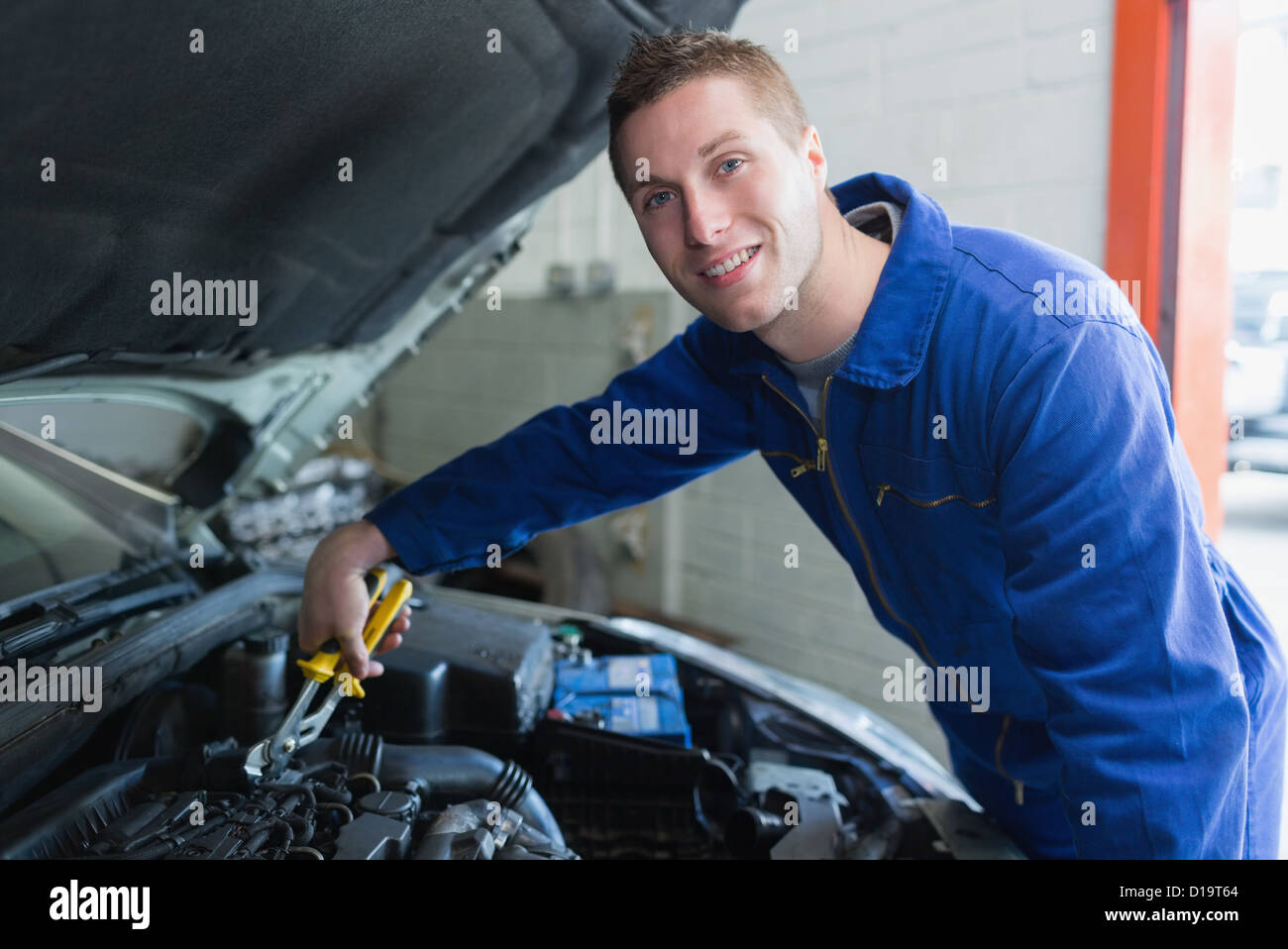 Male mechanic fixing car engine Stock Photo - Alamy