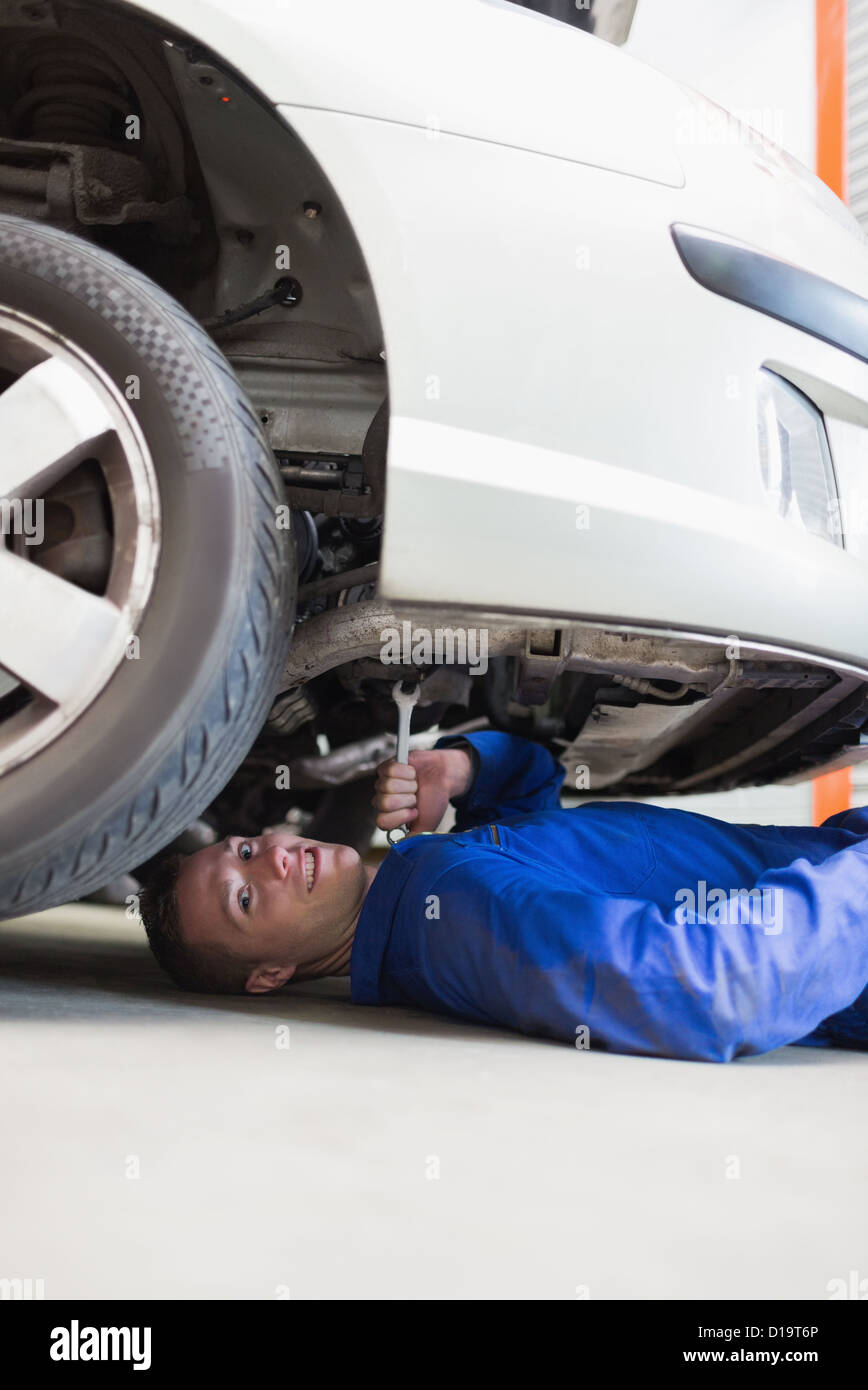 Auto mechanic working under car Stock Photo - Alamy