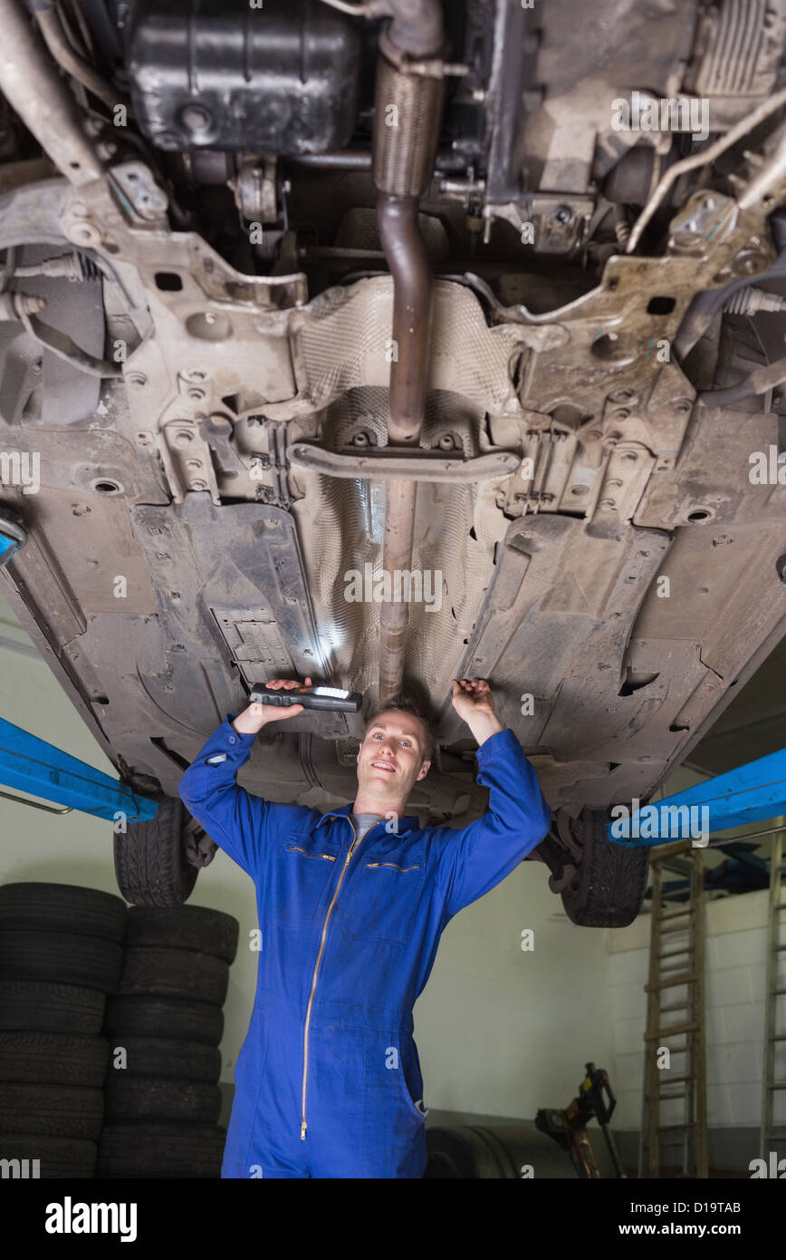 Portrait of mechanic working under car Stock Photo - Alamy