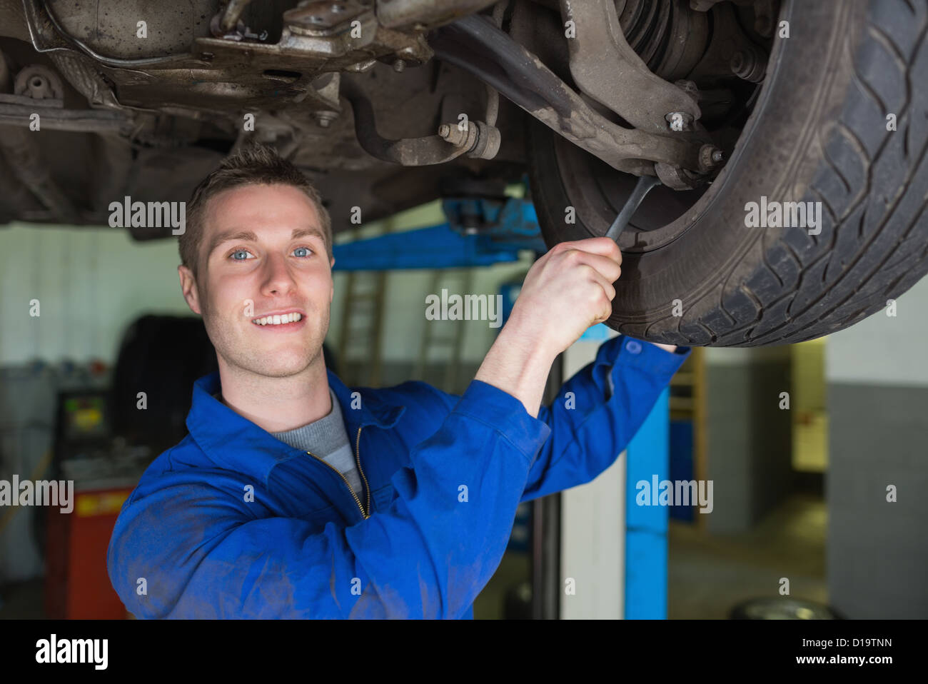 Mechanic repairing car with spanner Stock Photo - Alamy