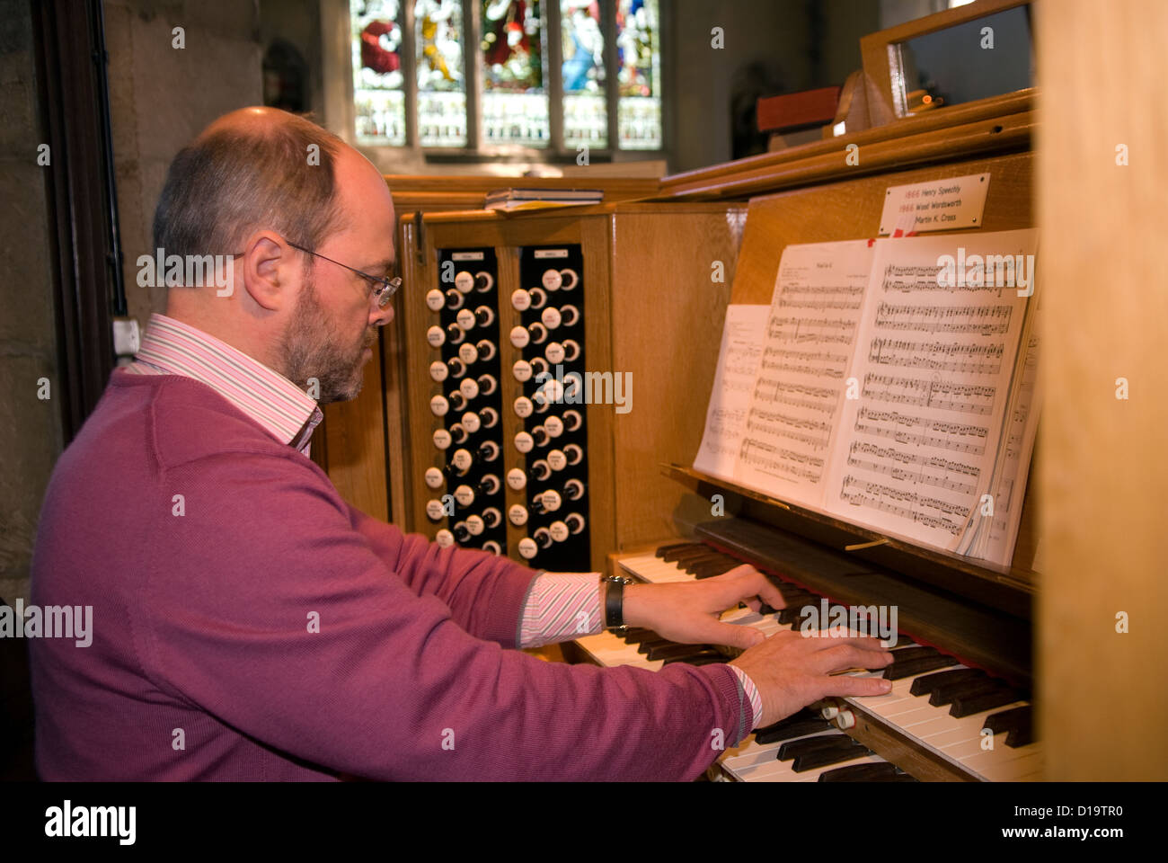 Church organist playing at St Lawrence Church, Alton, Hampshire, UK ...