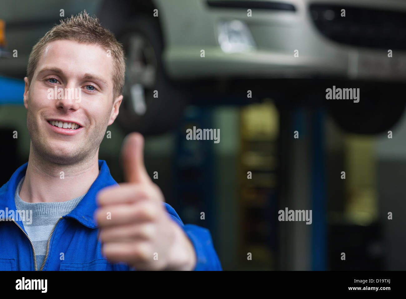 Smart car mechanic gesturing thumbs up Stock Photo - Alamy