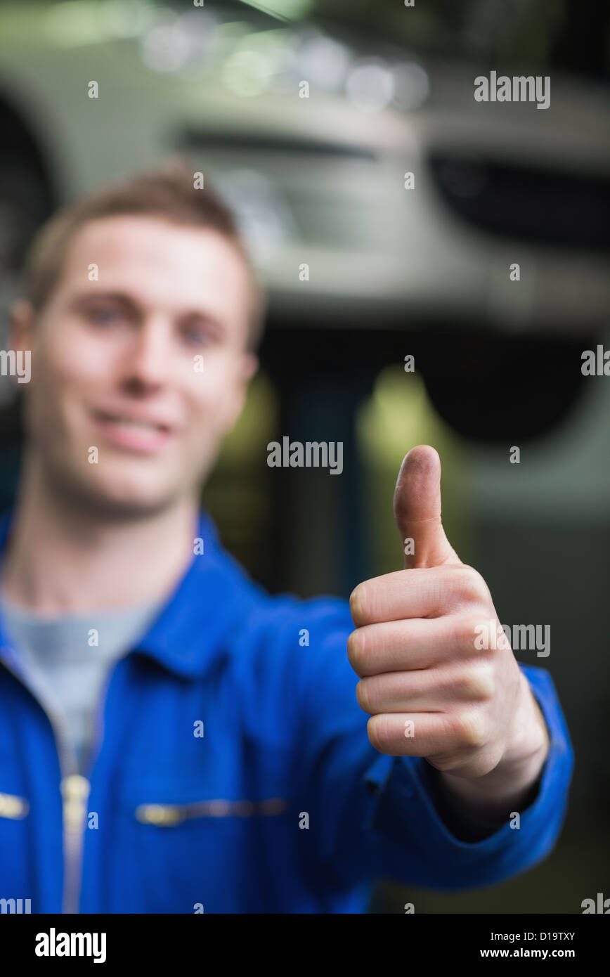 Repairman gesturing thumbs up Stock Photo - Alamy