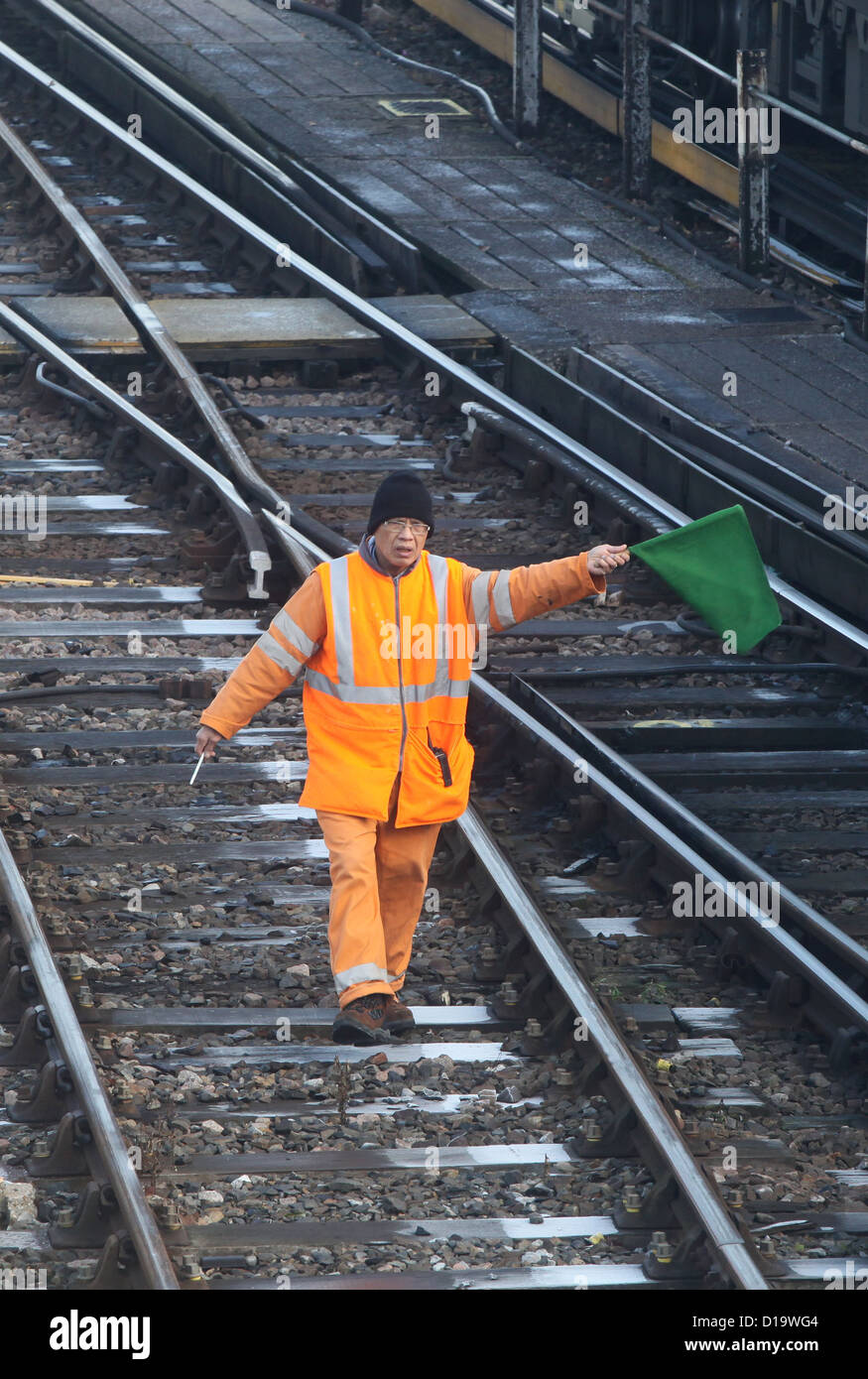A railway worker working on the tracks at Clapham Junction Railway ...