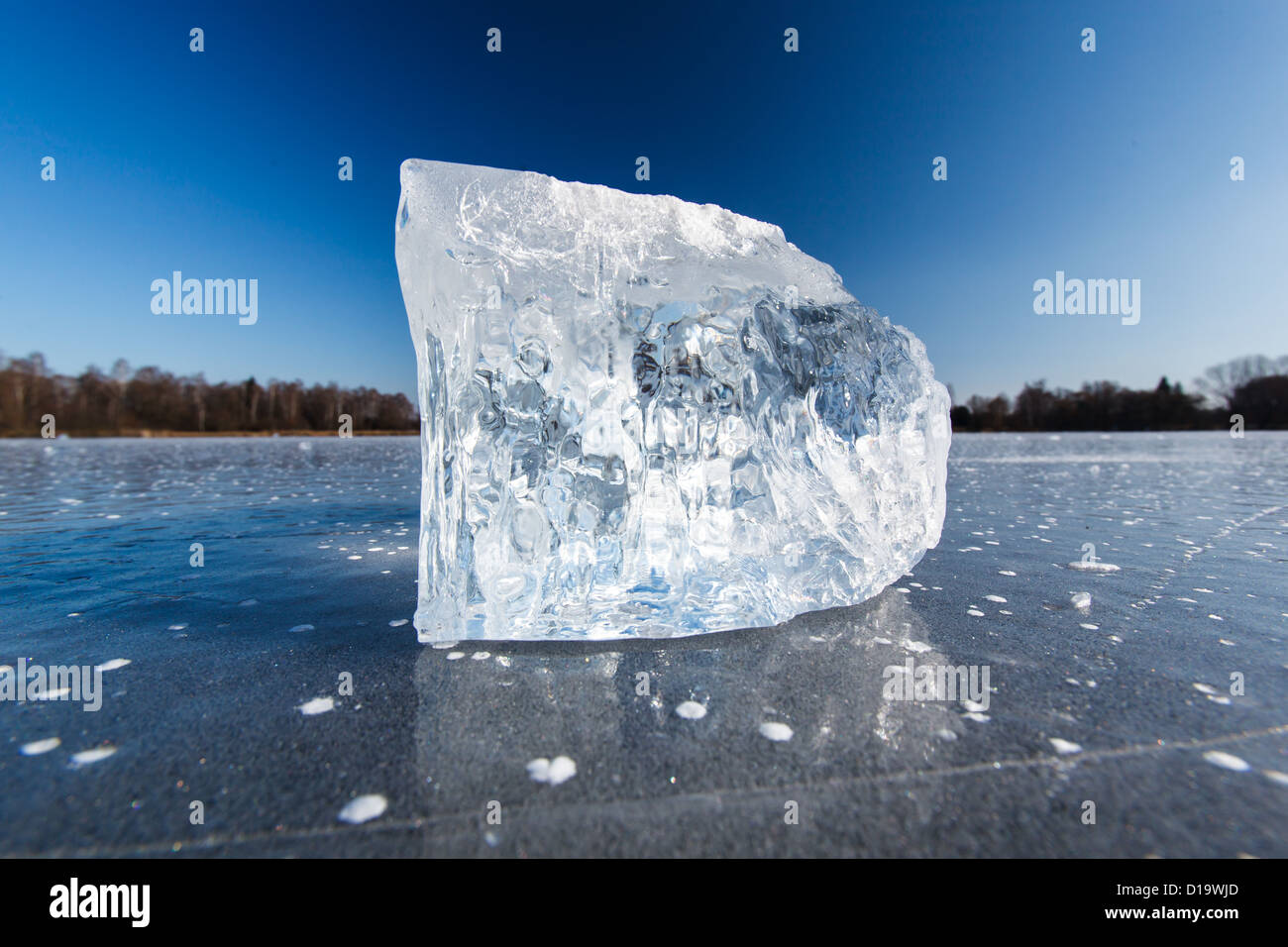 Freezing winter temperatures: block of ice lying on the surface of a ...