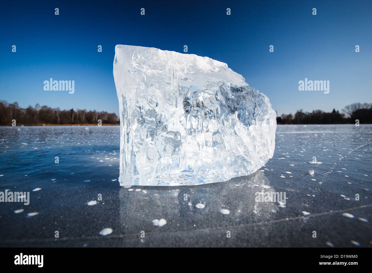 Freezing winter temperatures: block of ice lying on the surface of a ...